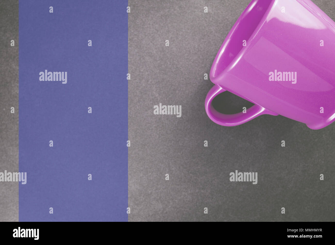 magenta tea cup on a rough dark stone surface - directly above view ...