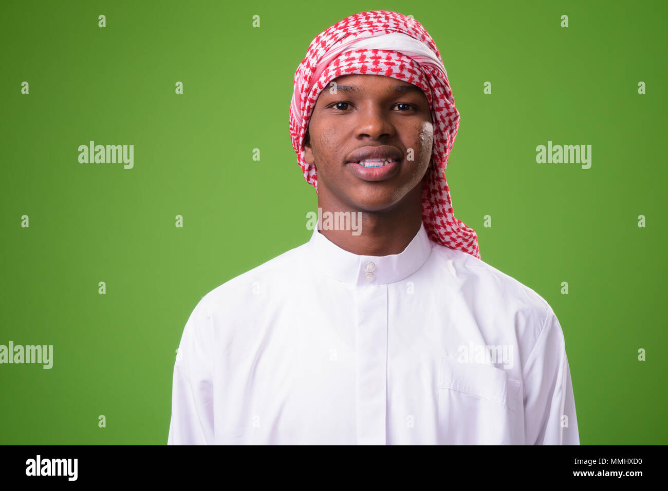 Young African man wearing traditional Muslim clothes against gre Stock ...