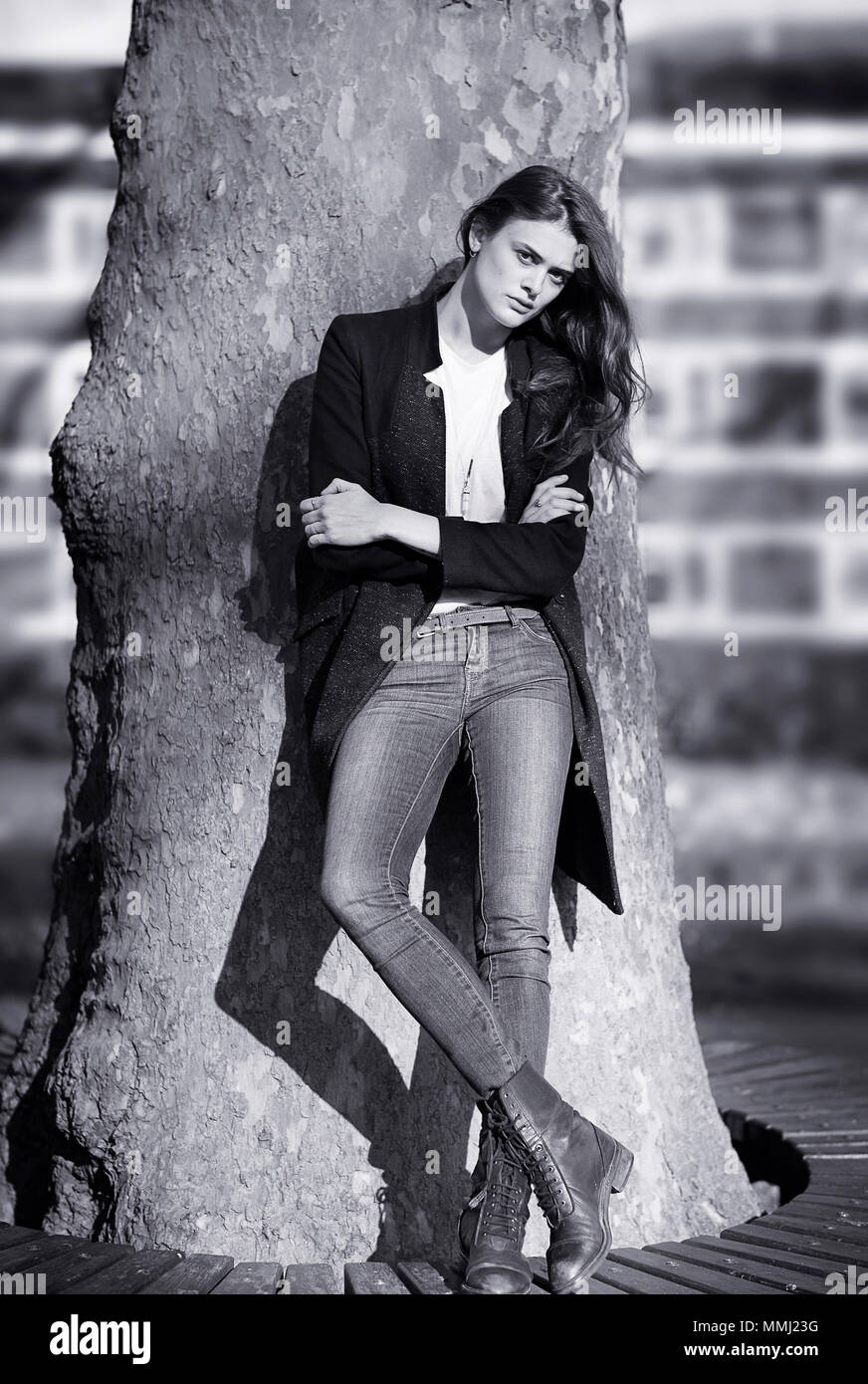 Model leaning against a tree Stock Photo - Alamy