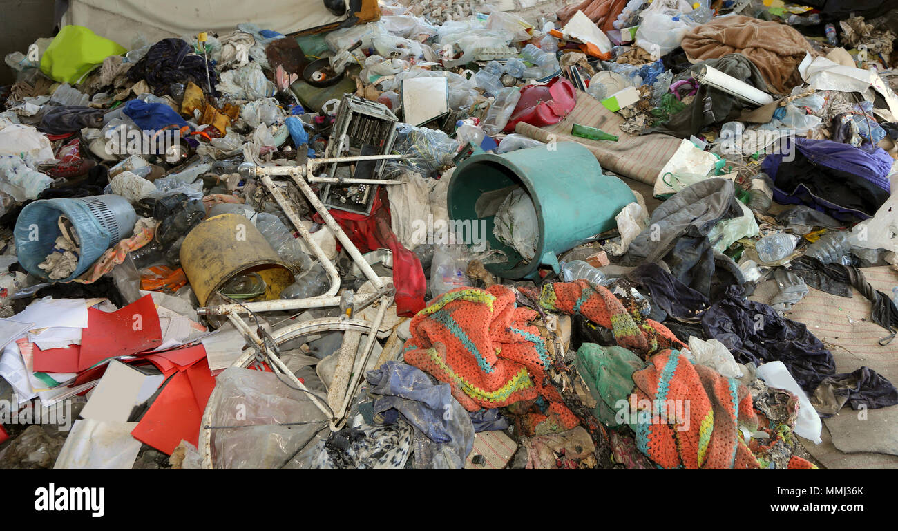 broken bike and many dirty object rags and garments in a abusive ...