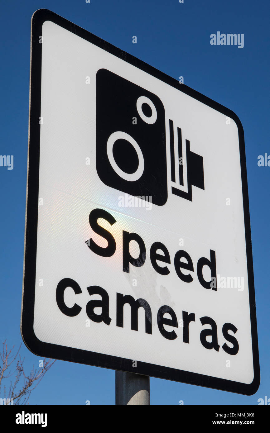 A Speed Cameras sign over a clear blue sky Stock Photo - Alamy