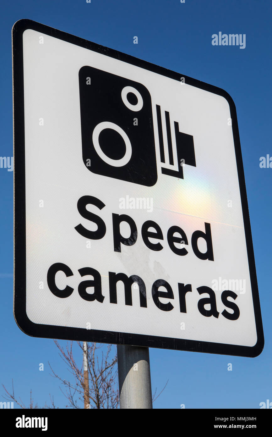A Speed Cameras sign over a clear blue sky Stock Photo - Alamy
