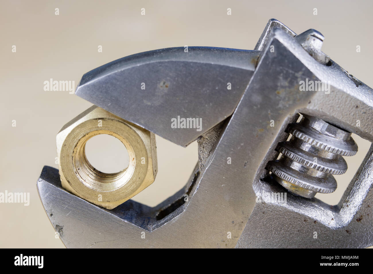 Metric screw and key on a wooden table. Mechanical accessories in the ...