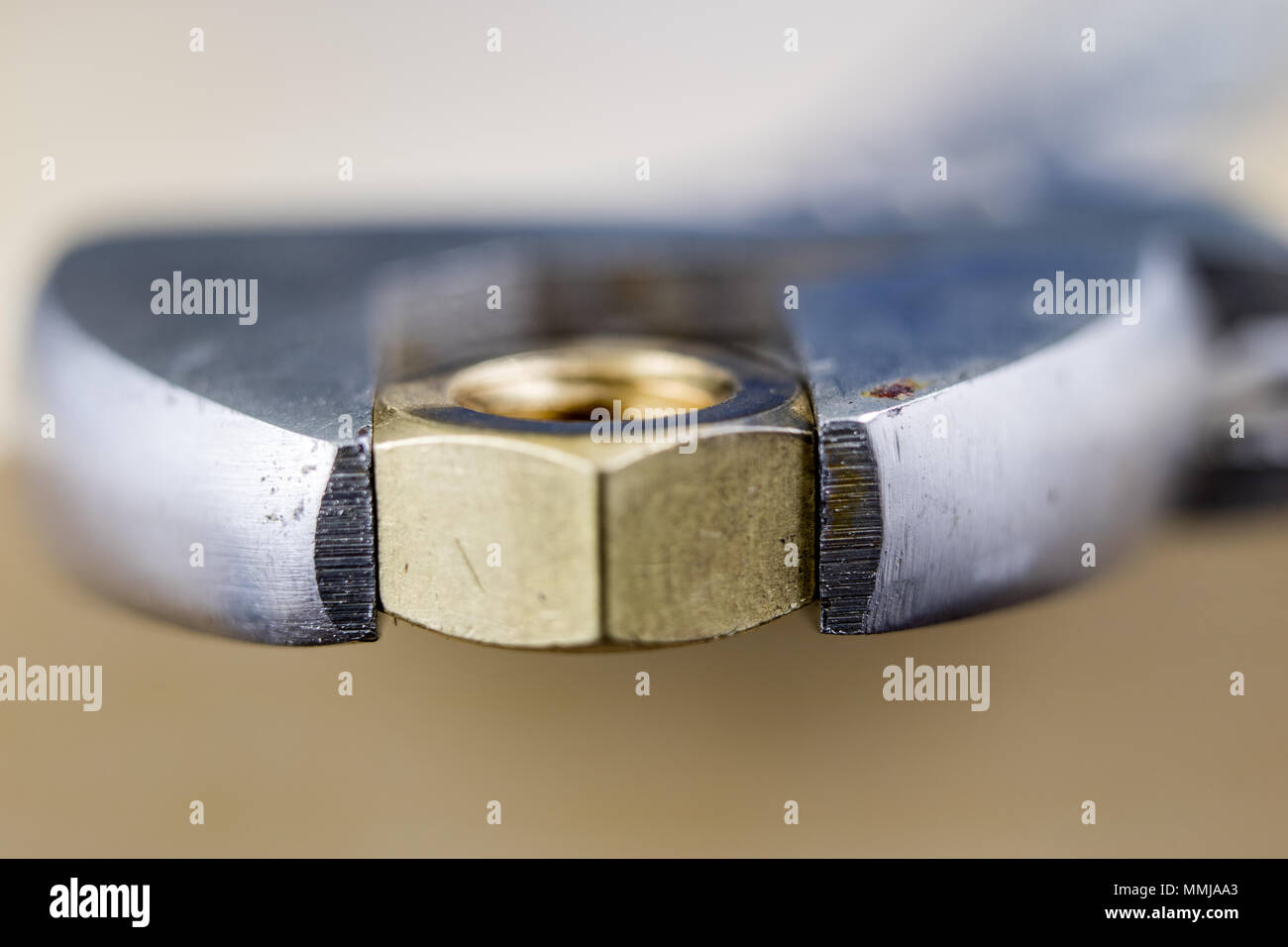Metric screw and key on a wooden table. Mechanical accessories in the ...