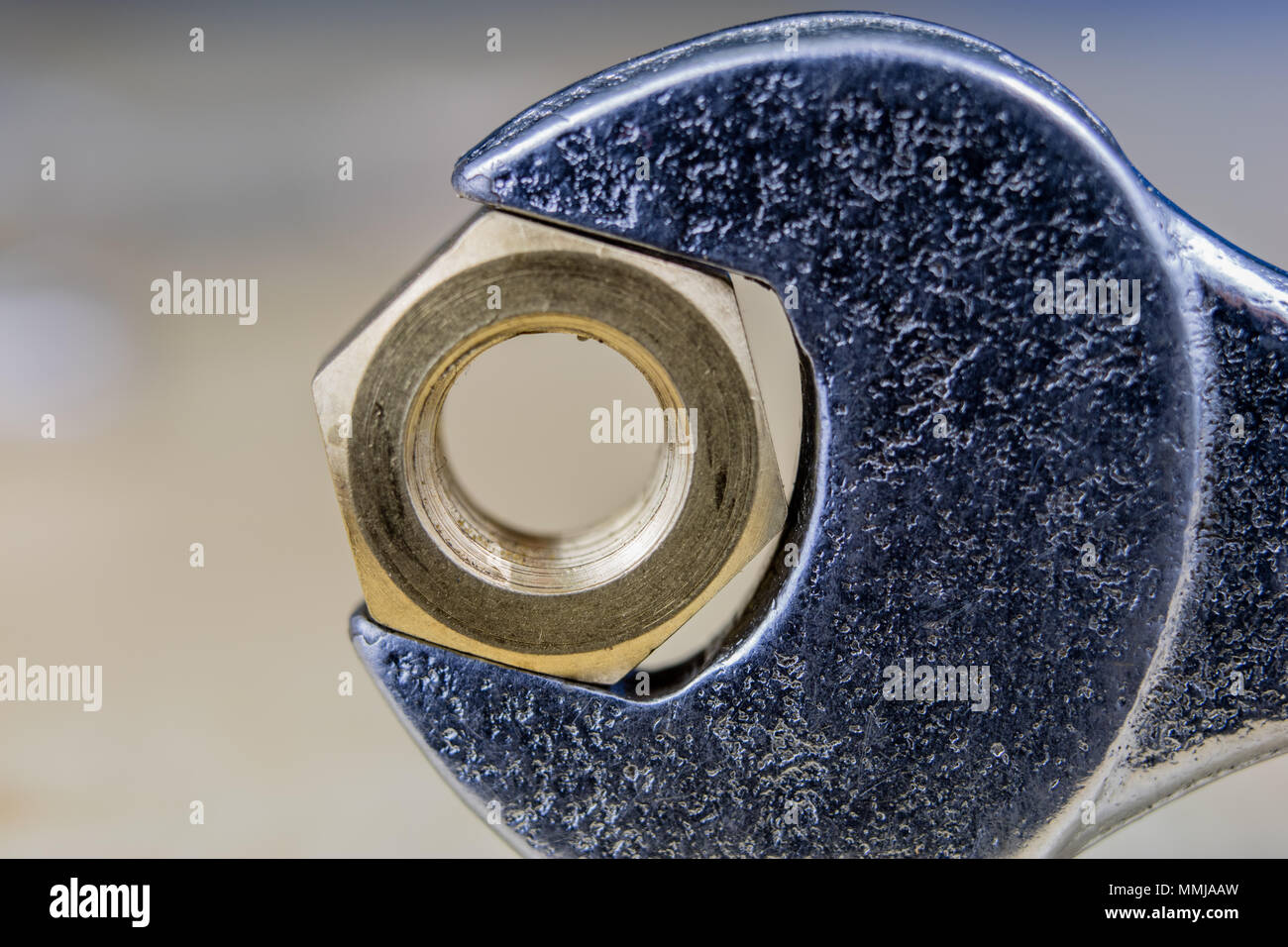 Metric screw and key on a wooden table. Mechanical accessories in the ...