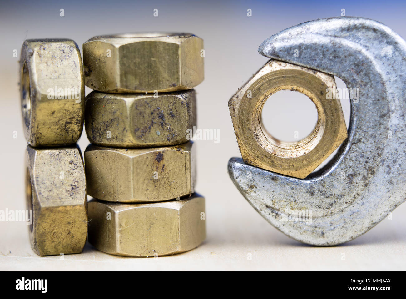 Metric screw and key on a wooden table. Mechanical accessories in the ...