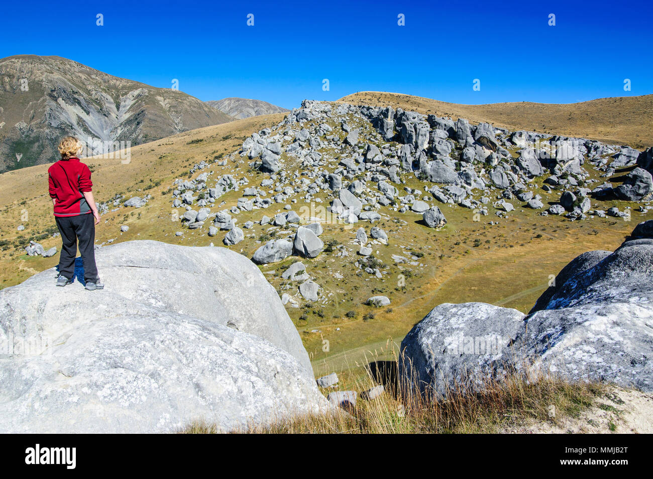 Woman standing on the Limestone outcrops of Castle Hill, South Island ...