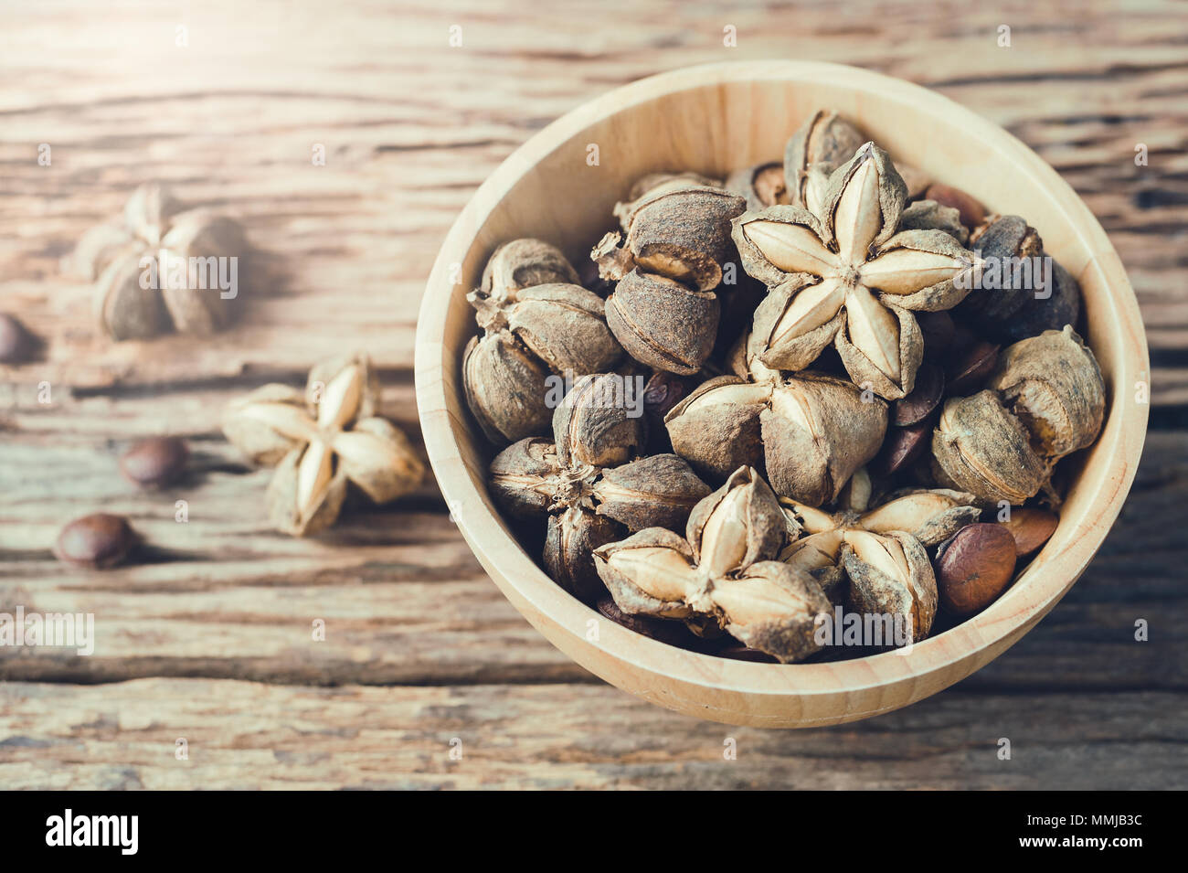 Dry sacha inchi seeds in wooden bowl on decay wood table background ...