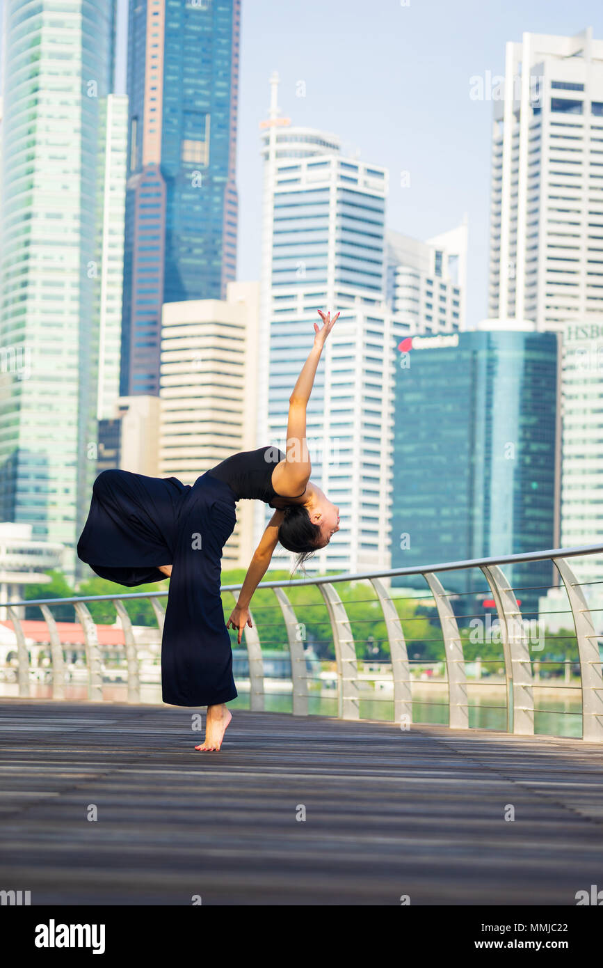 Elegant ballet dancer woman dancing ballet in the city of Singapore ...