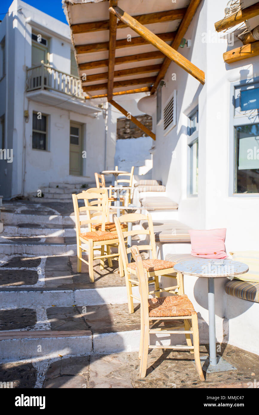 Outdoor cafe on a street of typical greek traditional village in Greece ...