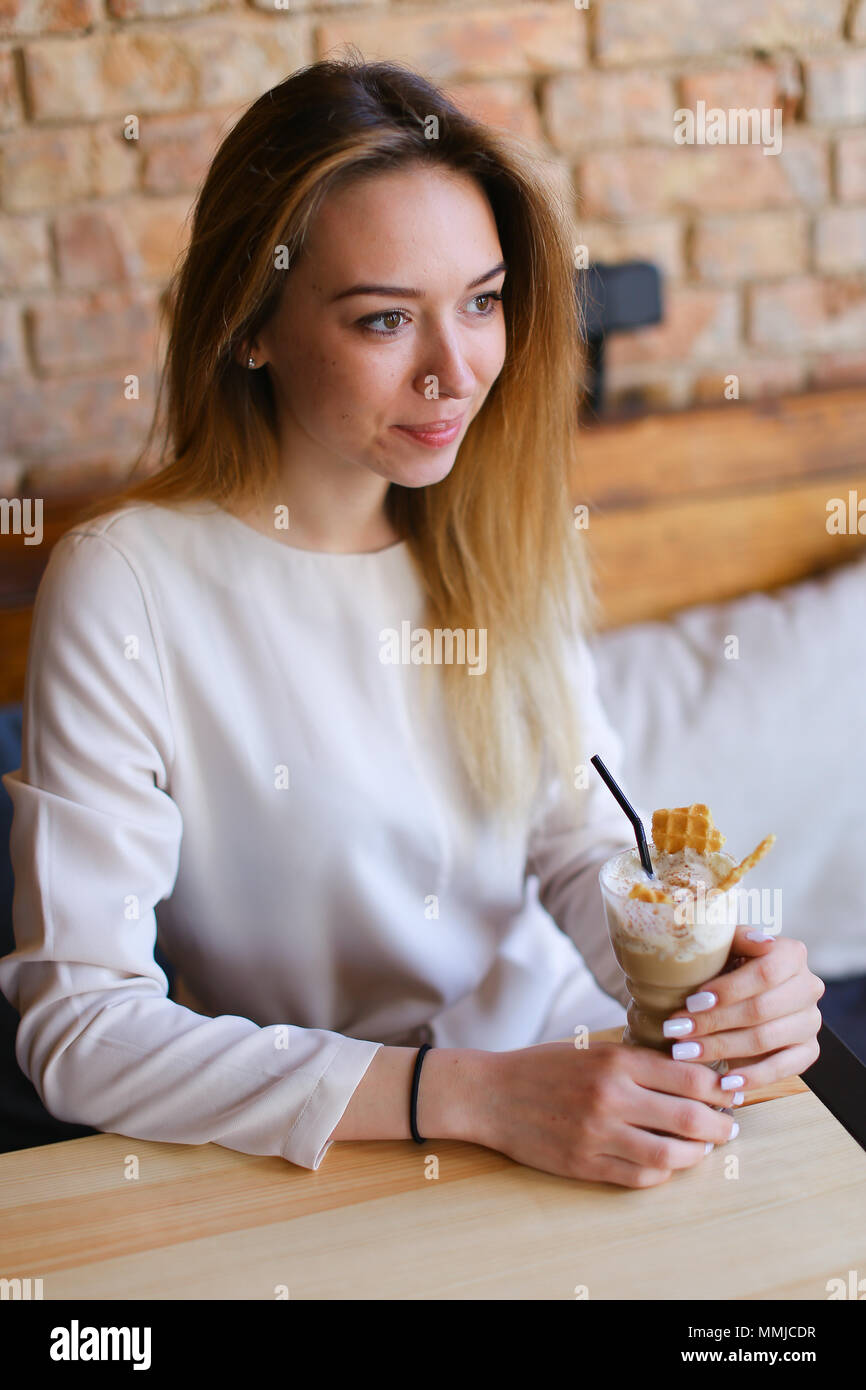 Young photo model sitting and having photo-session in stylized studio ...