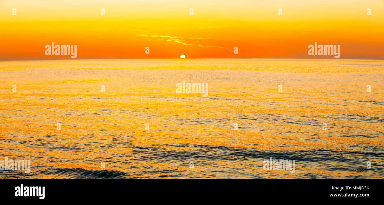 Sun Is Setting On Horizon At Sunset Sunrise Over Sea Or Ocean. Panorama ...