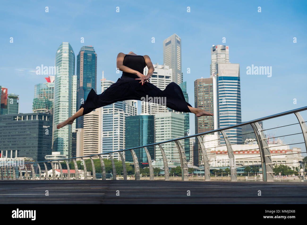 Elegant ballet dancer woman dancing ballet in the city of Singapore ...