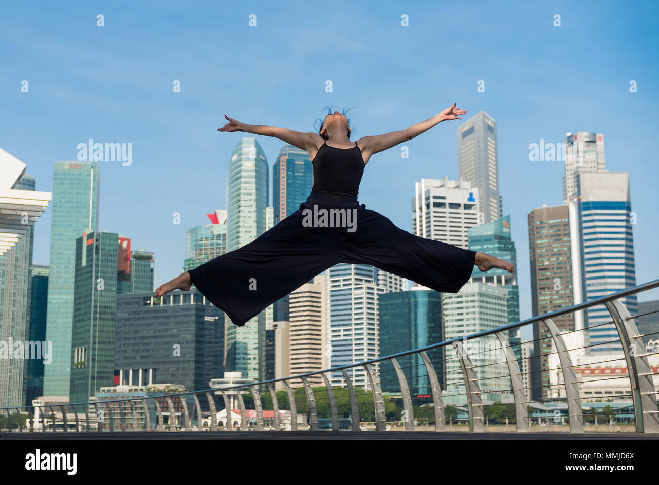 Elegant ballet dancer woman dancing ballet in the city of Singapore ...