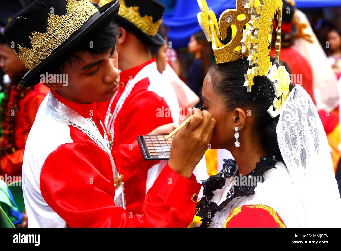 ANTIPOLO CITY, PHILIPPINES - MAY 1, 2018: A man fixes the makeup of a ...