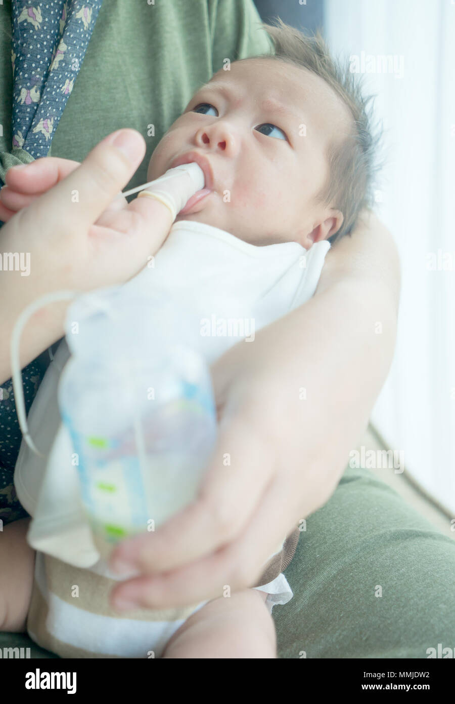 Finger Feeding breast milk to newborn baby boy using small tube Stock ...
