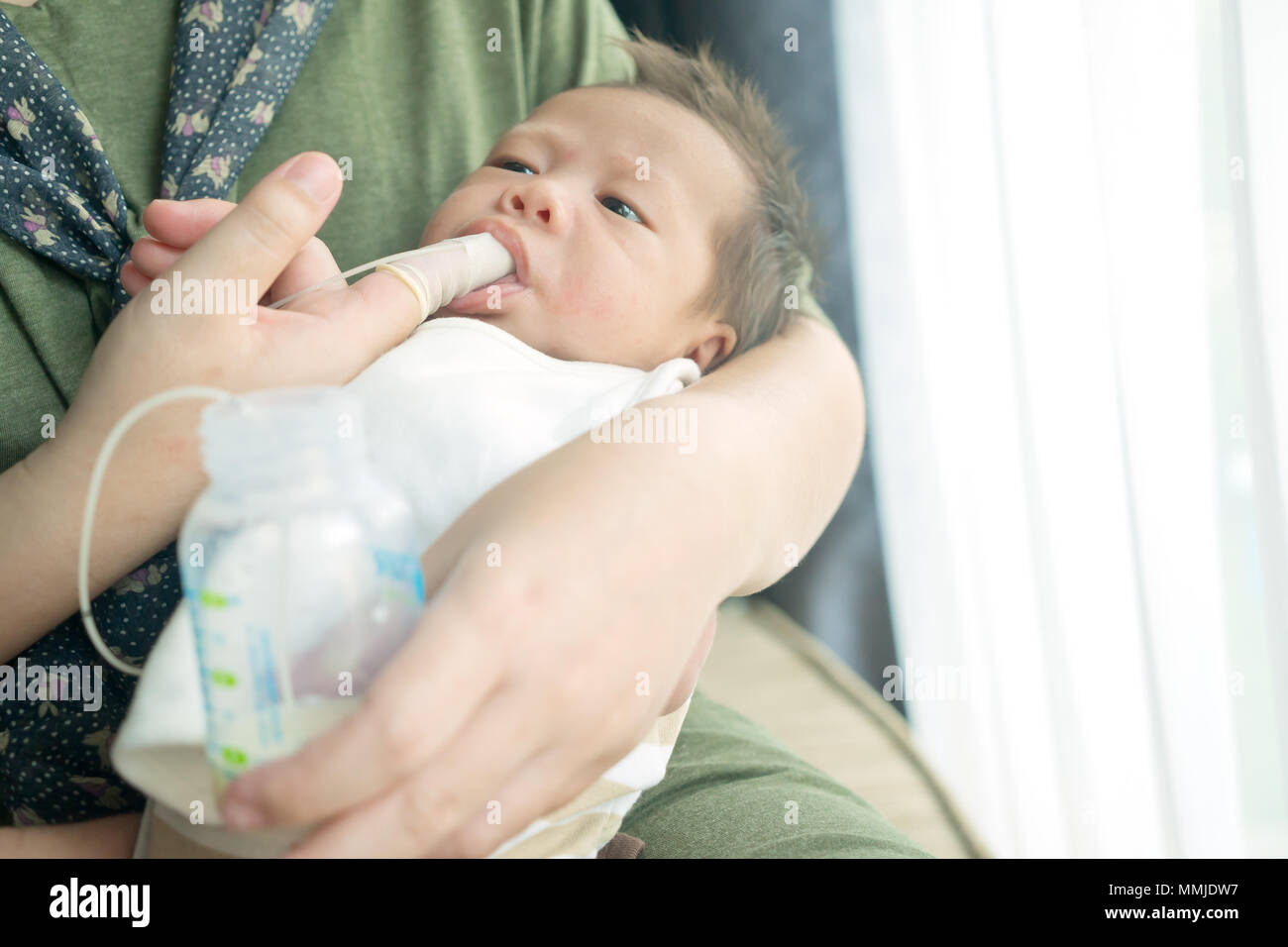 Finger Feeding breast milk to newborn baby boy using small tube Stock ...