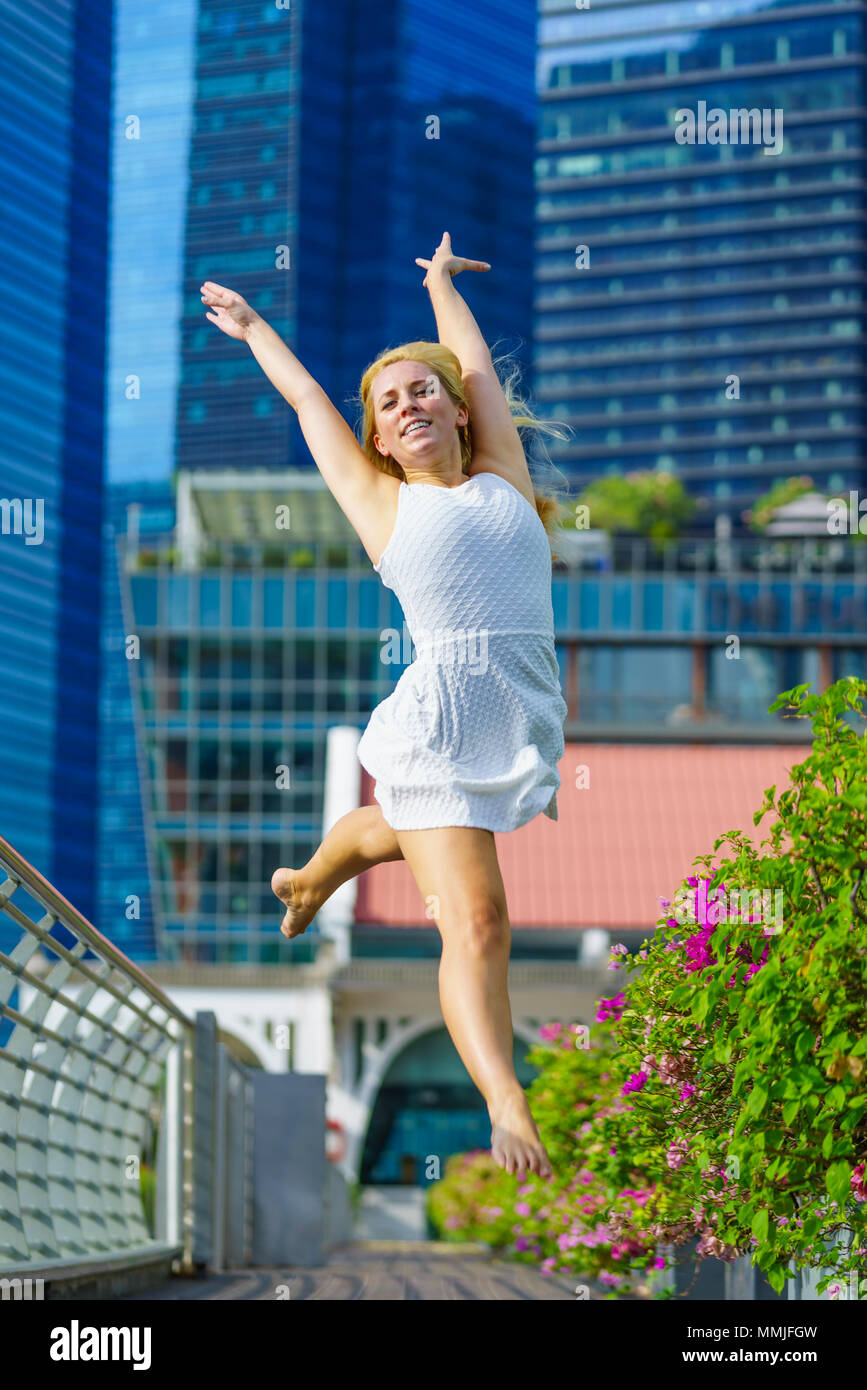Elegant ballet dancer woman dancing ballet in the city of Singapore ...
