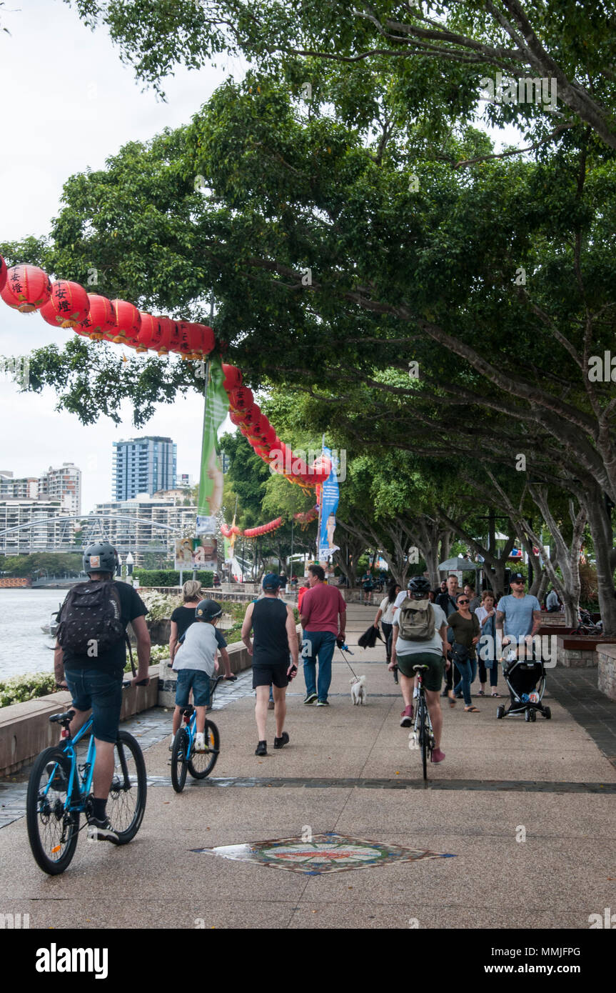 Cyclists and pedestrians share a riverside promenade on South Bank ...