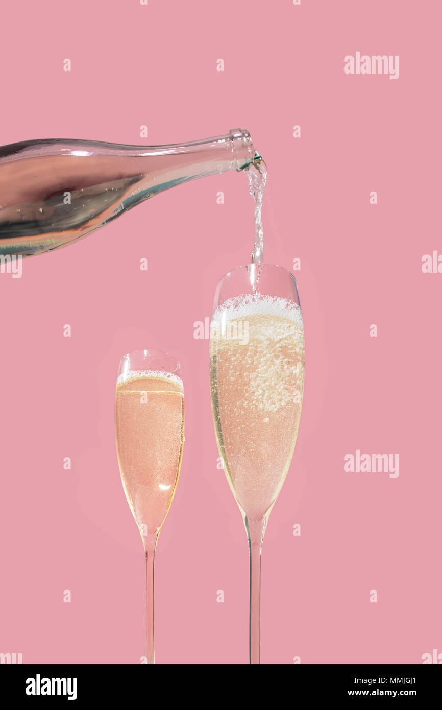 Valdobbiadene Prosecco flutes and a bottle, pink background, in pop ...