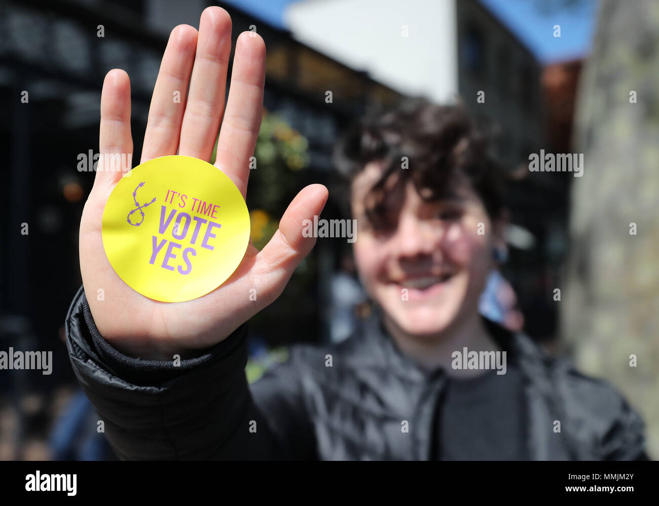 A volunteer from Amnesty Inernational hands out stickers calling for a ...