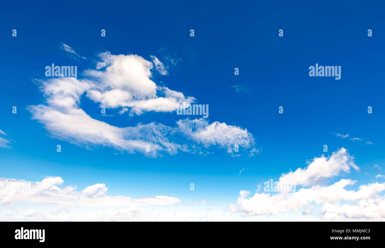 amazing cloud formations on a bright blue sky. beautiful cloudscape in ...