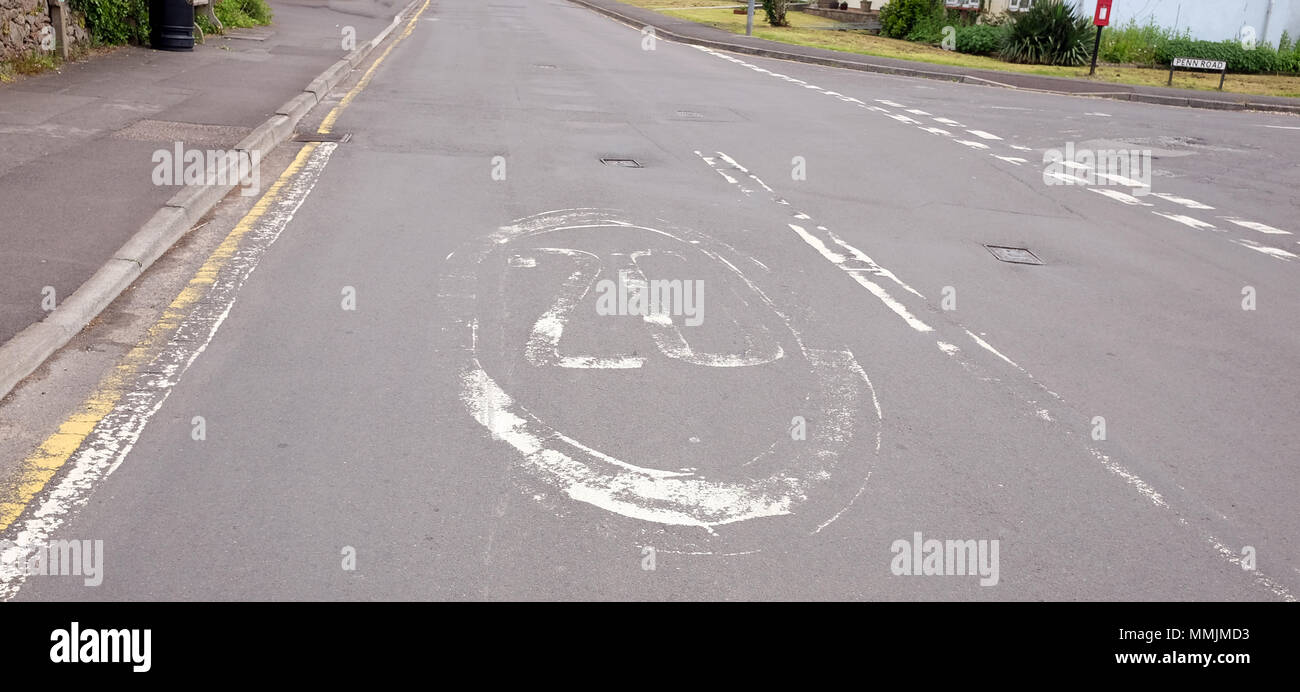 May 2018 - Well worn road sign speed limit painted on the road near a ...
