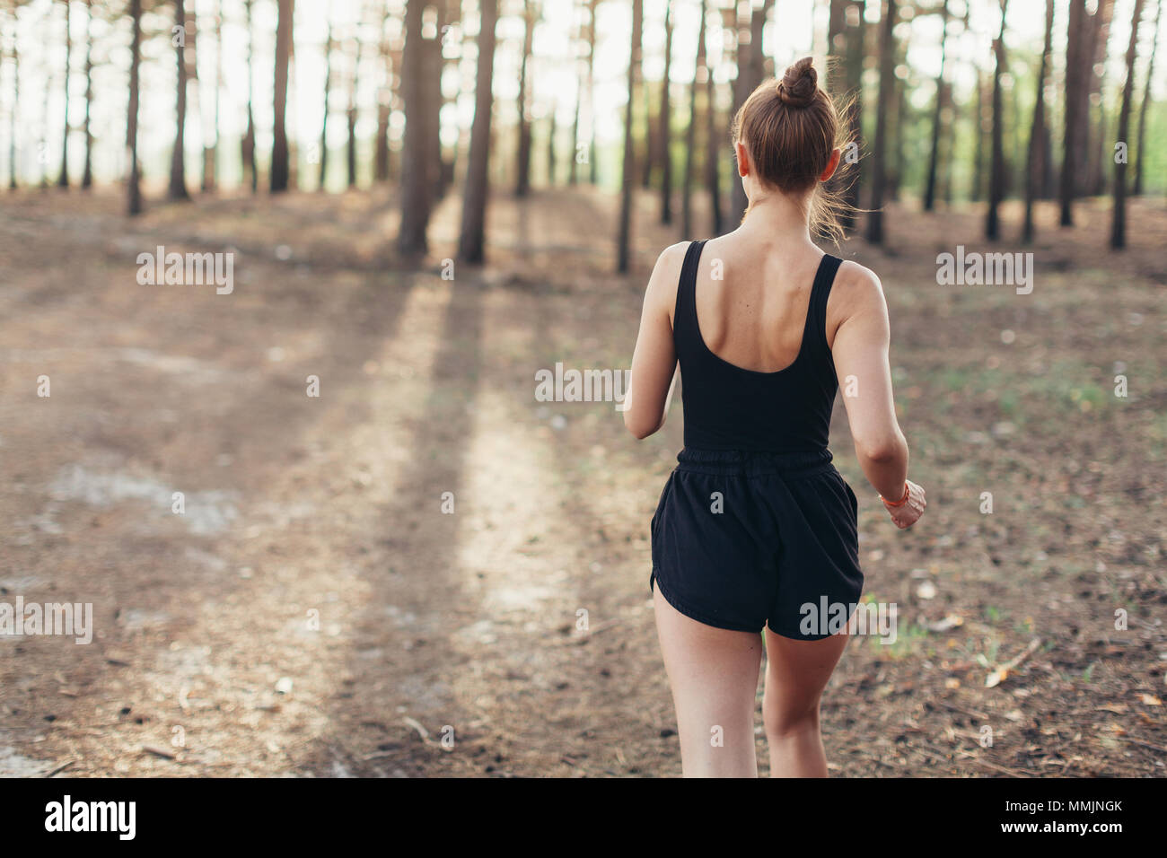 healthy lifestyle brunet fitness sporty woman runner running in pine ...