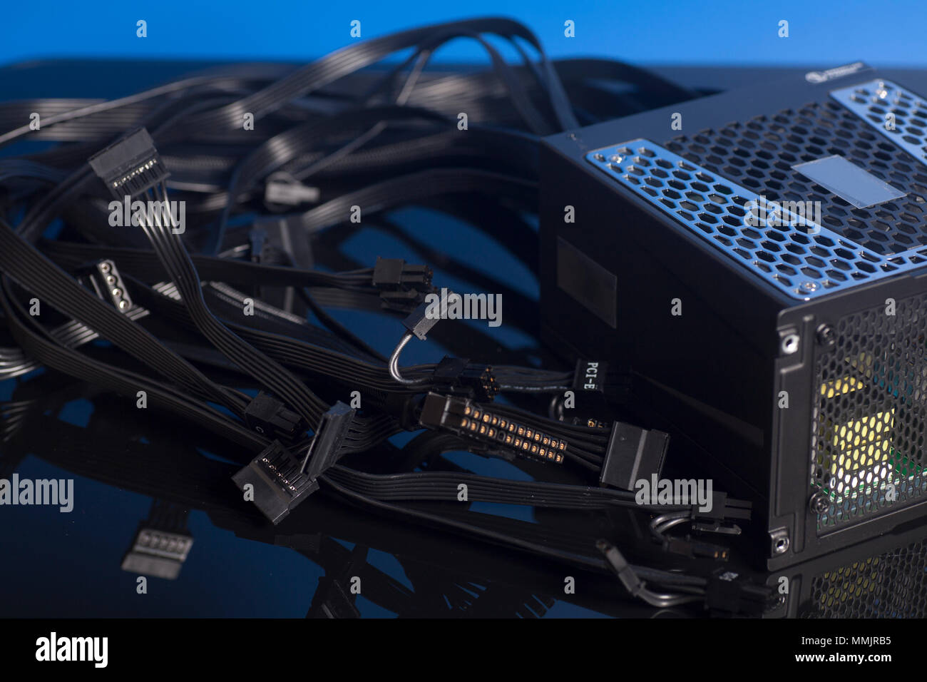 Computer Power Supply Unit with cable on blue background Stock Photo ...