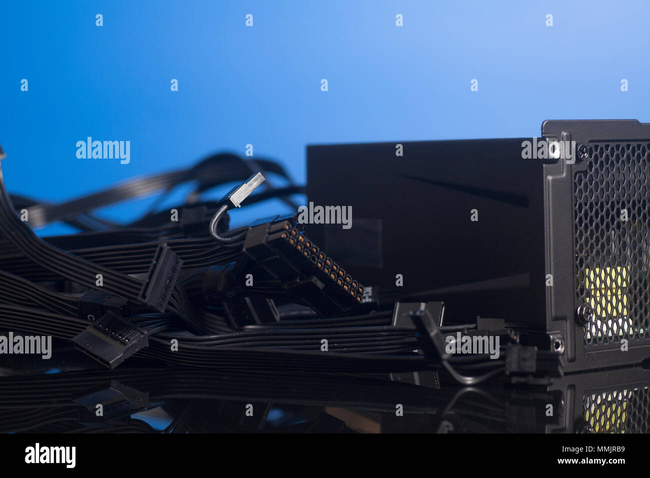 Computer Power Supply Unit with cable on blue background Stock Photo ...