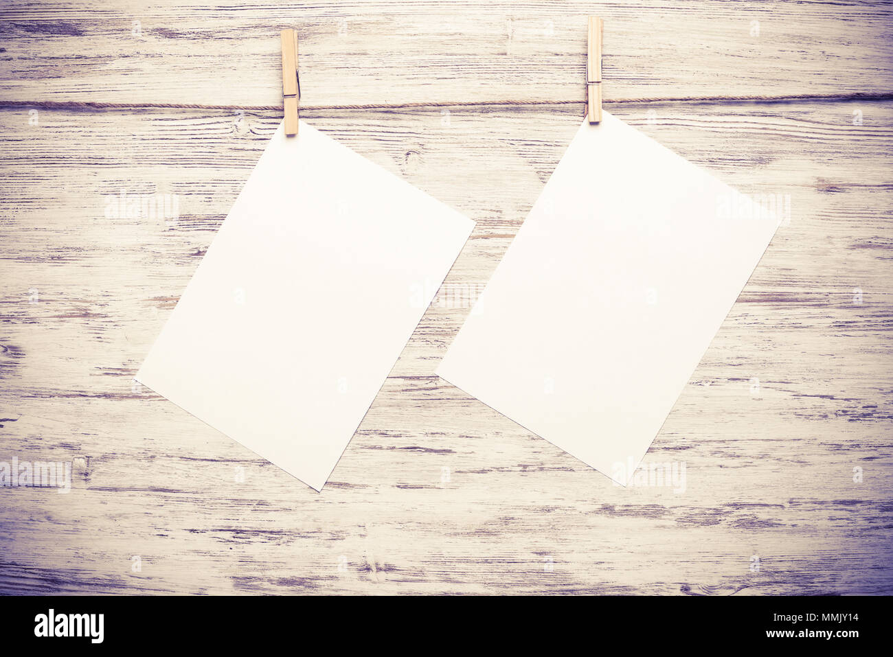Blank paper sheets for text hanging on rope Stock Photo - Alamy