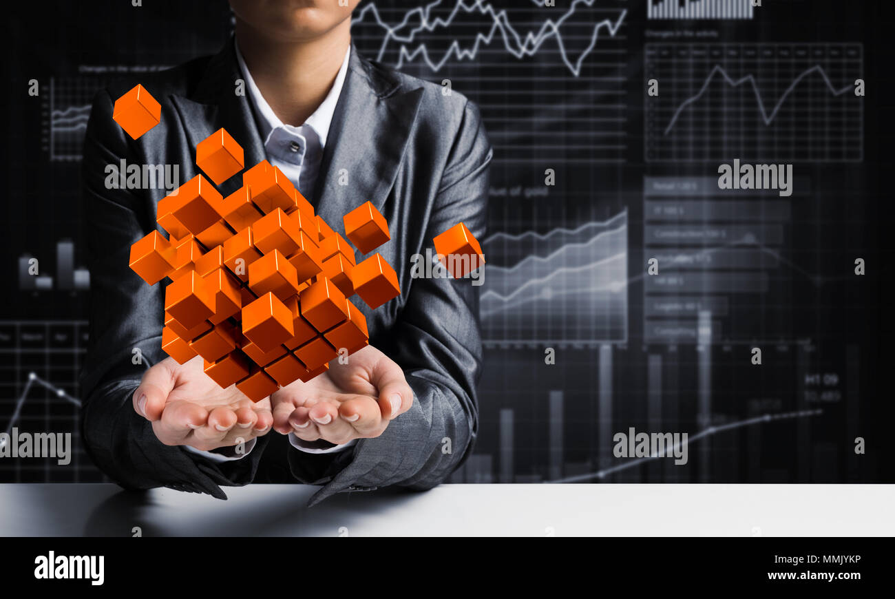Cropped image of business woman in suit presenting multiple cubes in ... Cropped image of business woman in suit presenting multiple cubes in ...