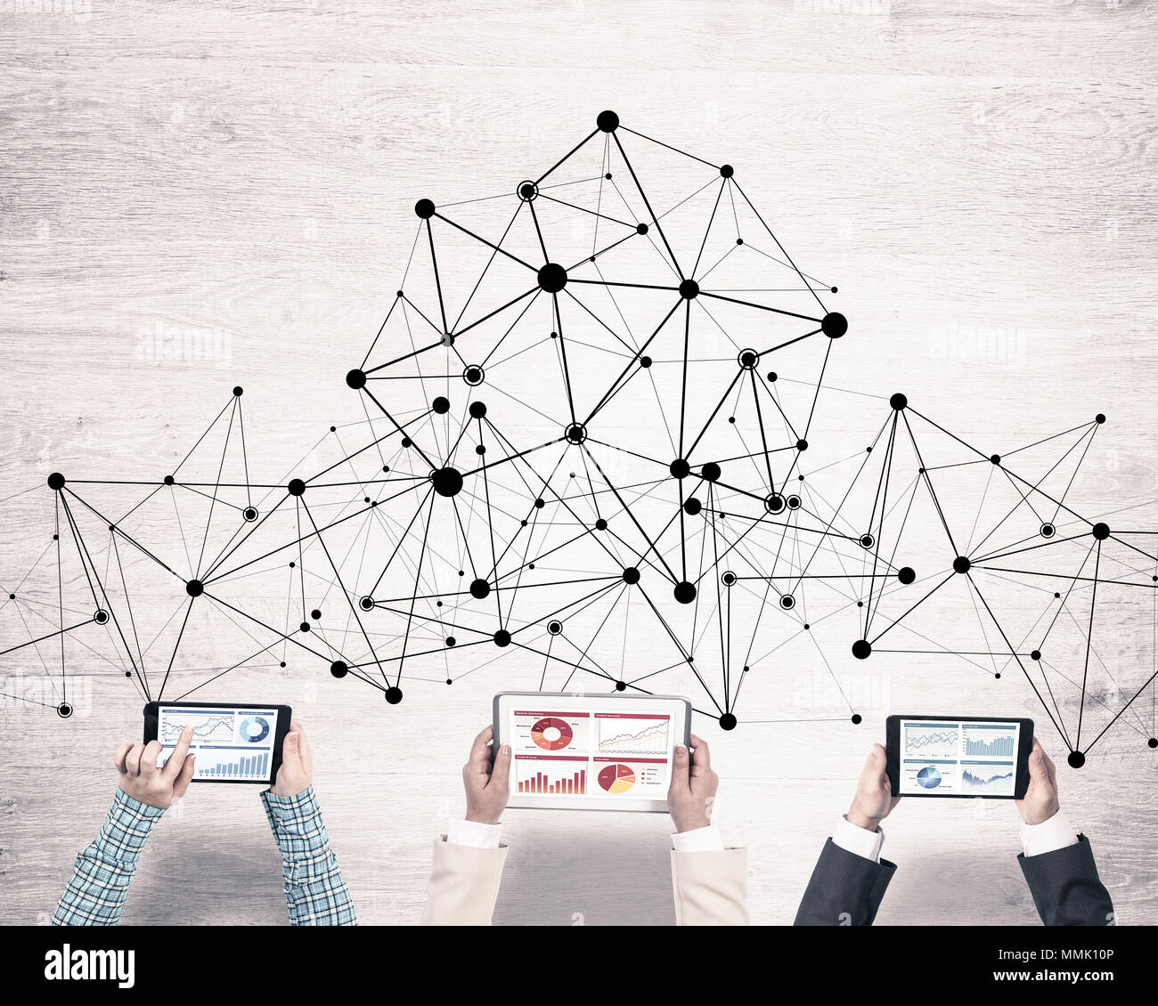 Group of three people with devices in hands working together as symbol ...