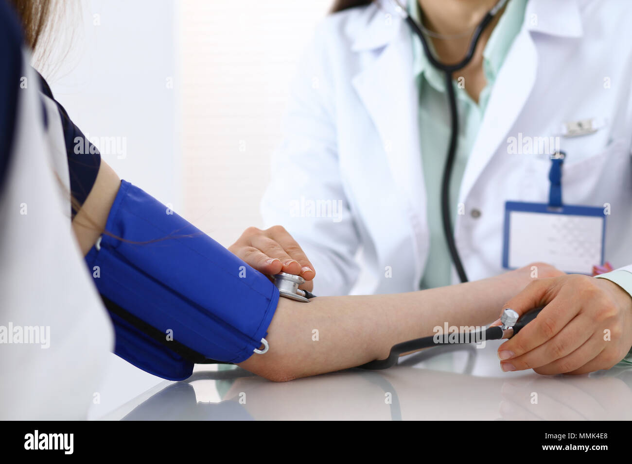 Doctor checking blood pressure of the patient, closeup. Cardiology in ...
