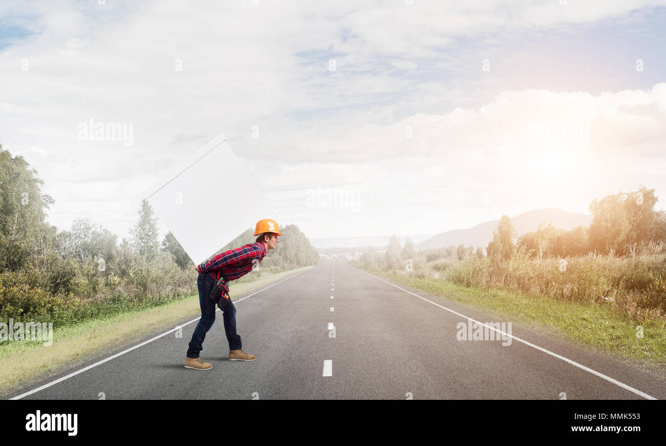 Man carrying on his back large box Stock Photo - Alamy