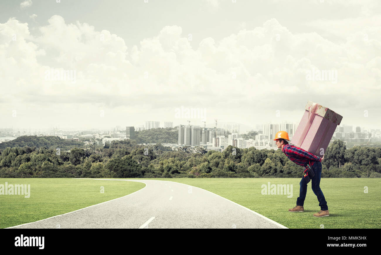 Man carrying on his back large box Stock Photo - Alamy