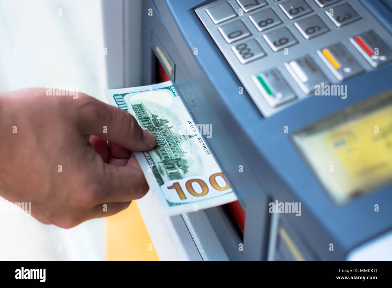 Taking money out of the ATM Stock Photo - Alamy