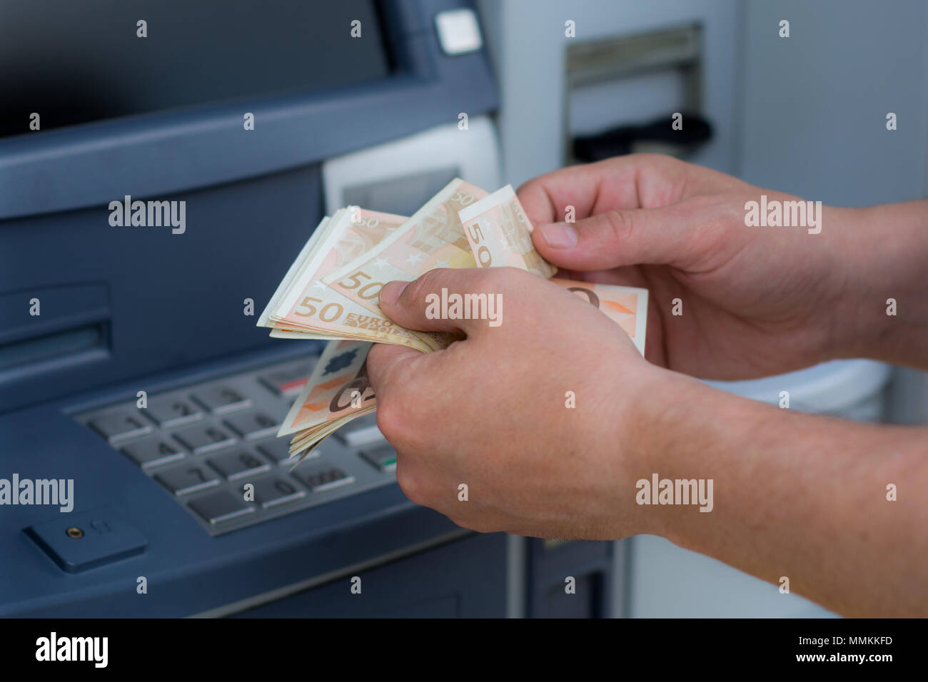 Taking money out hi-res stock photography and images - Alamy