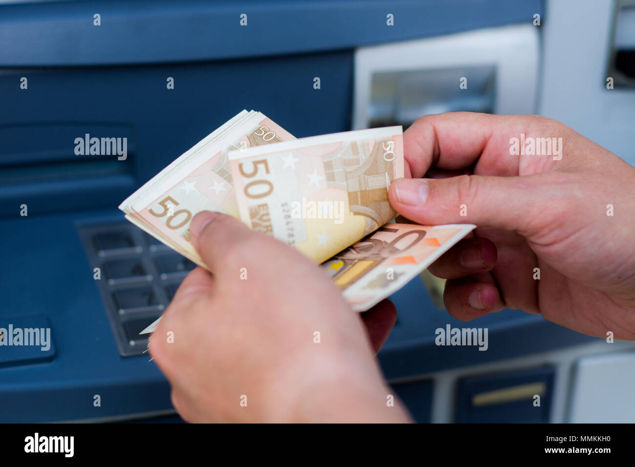 Taking money out of the ATM Stock Photo - Alamy