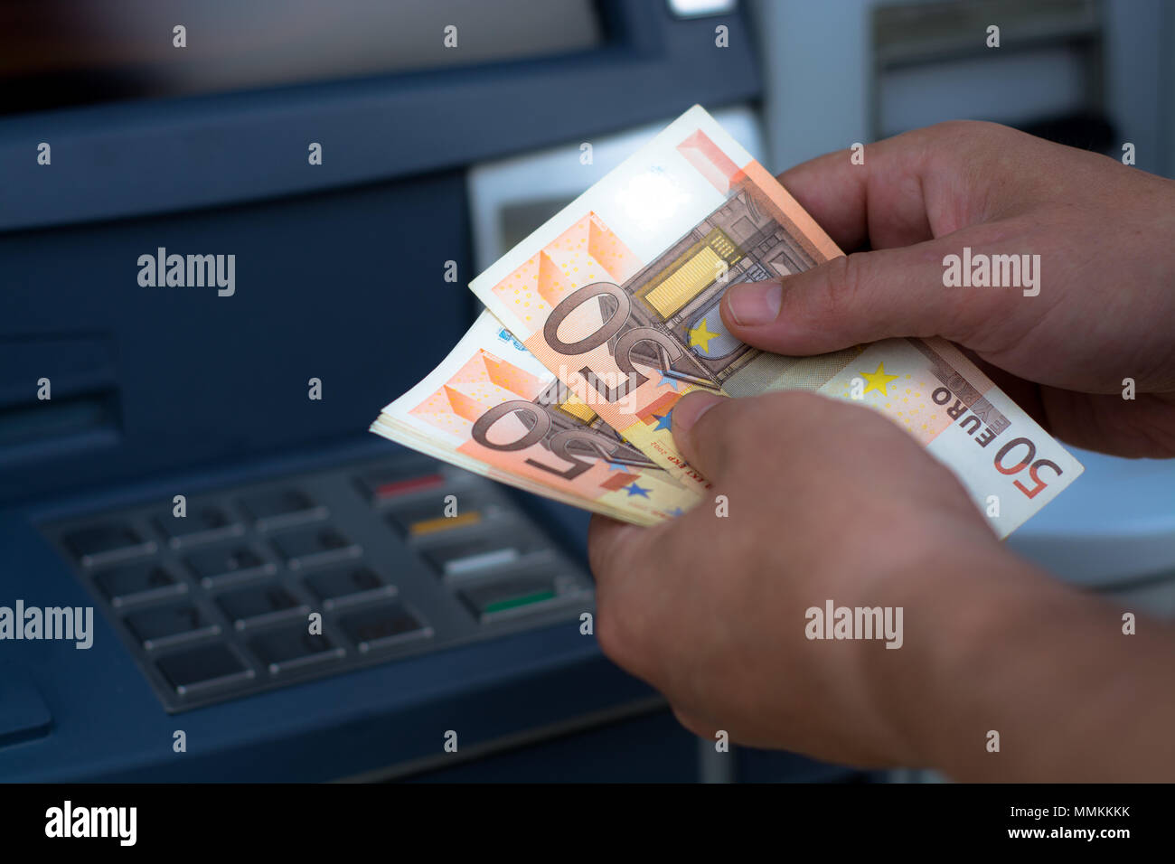 Taking money out of the ATM Stock Photo - Alamy
