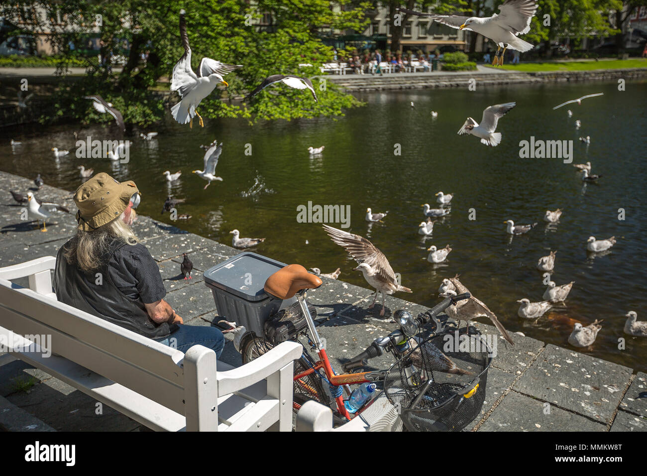 Stavanger, Norway - June 16, 2014: A homeless man sitting on the bench ...