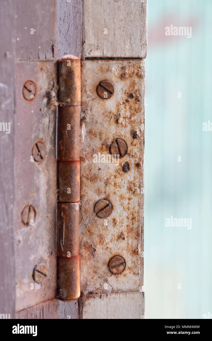 old and rusty door hinge on wooden frame Stock Photo - Alamy