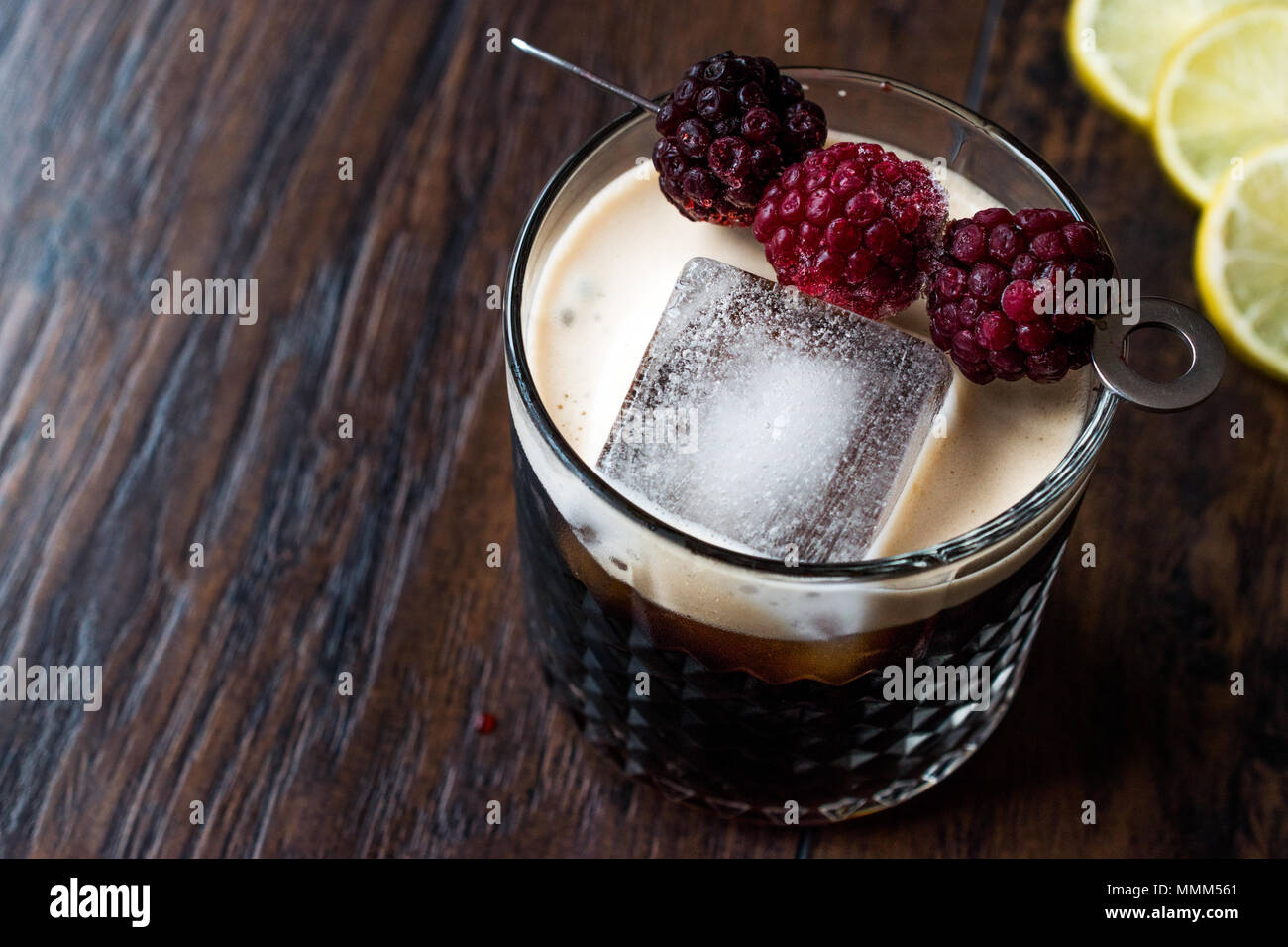 Black / Dark Beer Cocktail with Blackberries and Ice on Wooden Surface ...