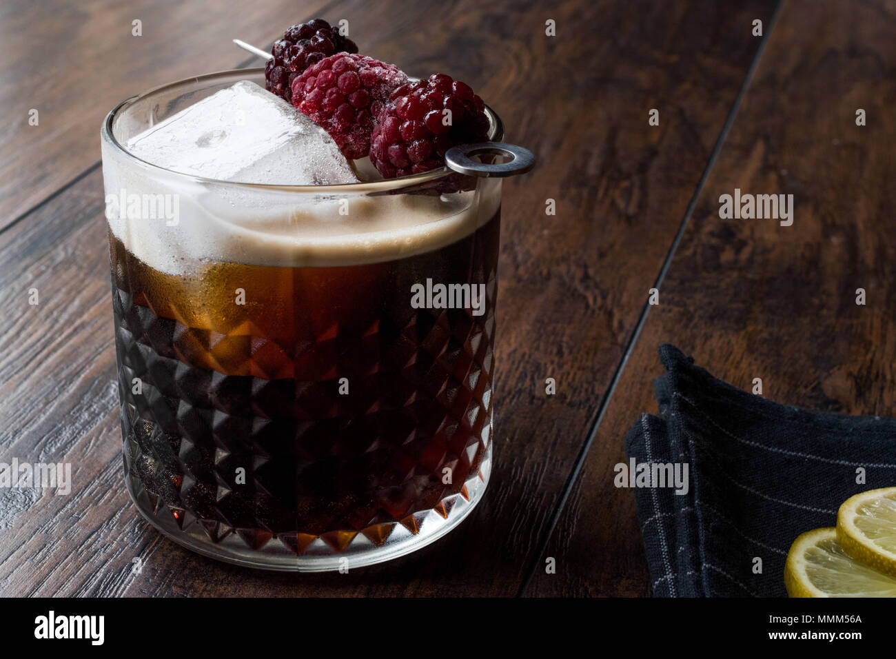 Black / Dark Beer Cocktail with Blackberries and Ice on Wooden Surface ...