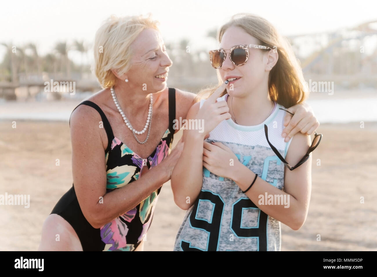 Cute pretty teen daughter with mature mother hugging in nature at ...