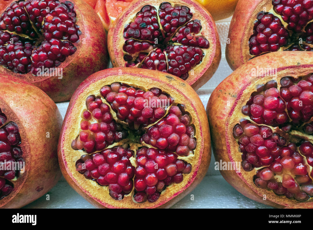 Cut fresh tasty pomegranates with large juicy red grains Stock Photo ...