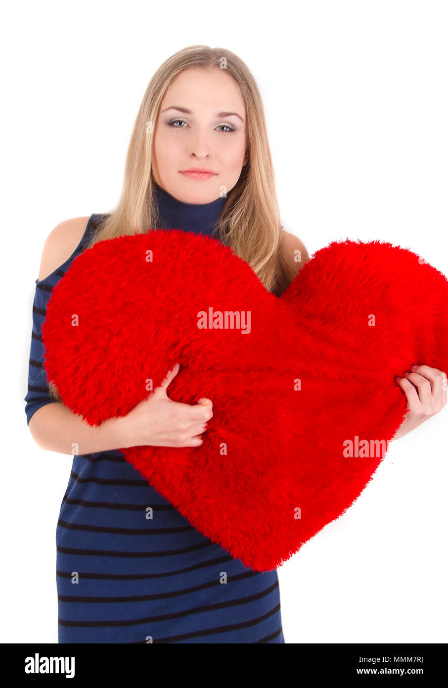 Young beautiful girl hugs a big soft heart. Feast of St. Valentine's ...