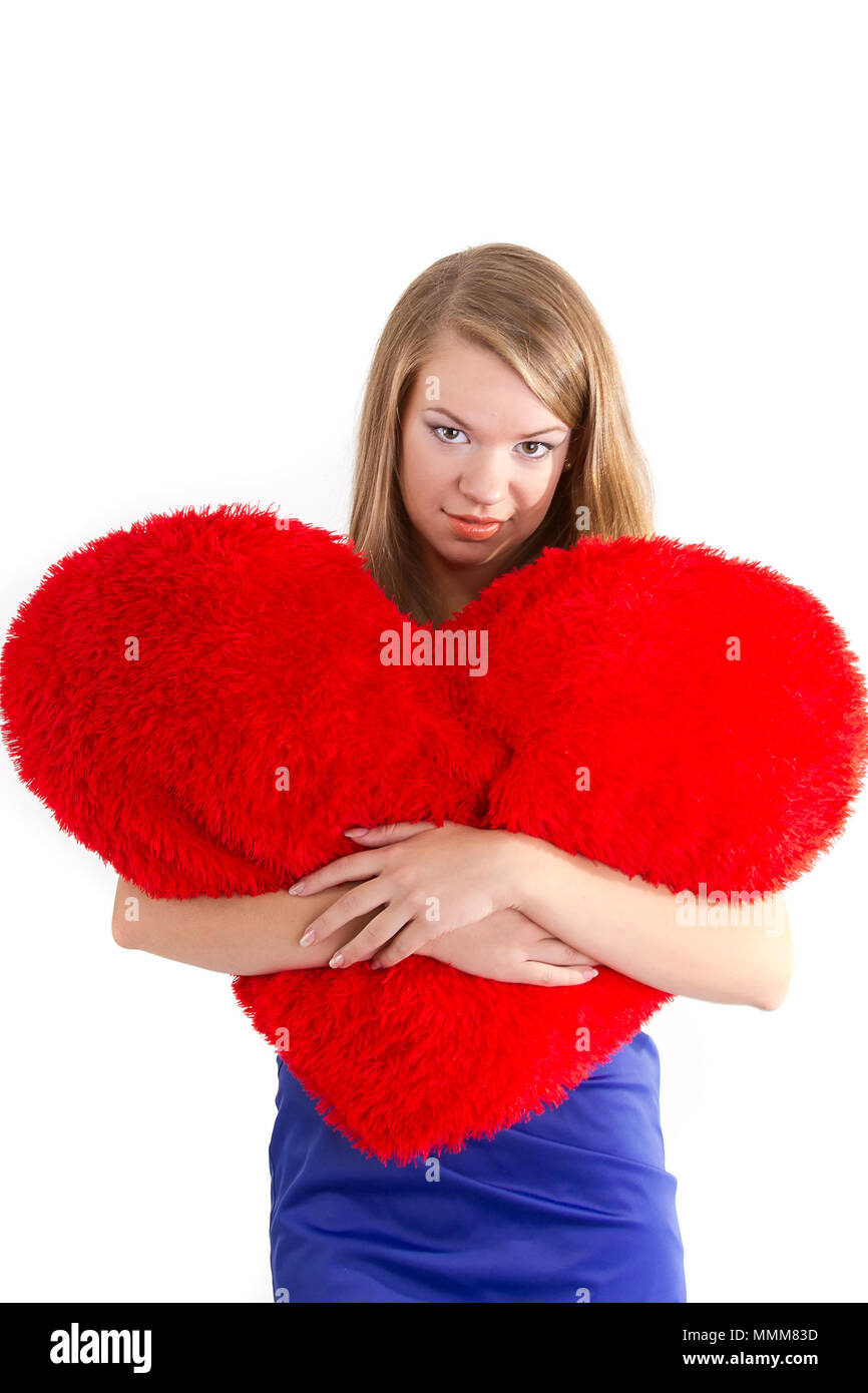 Young beautiful girl hugs a big soft heart. Feast of St. Valentine's ...