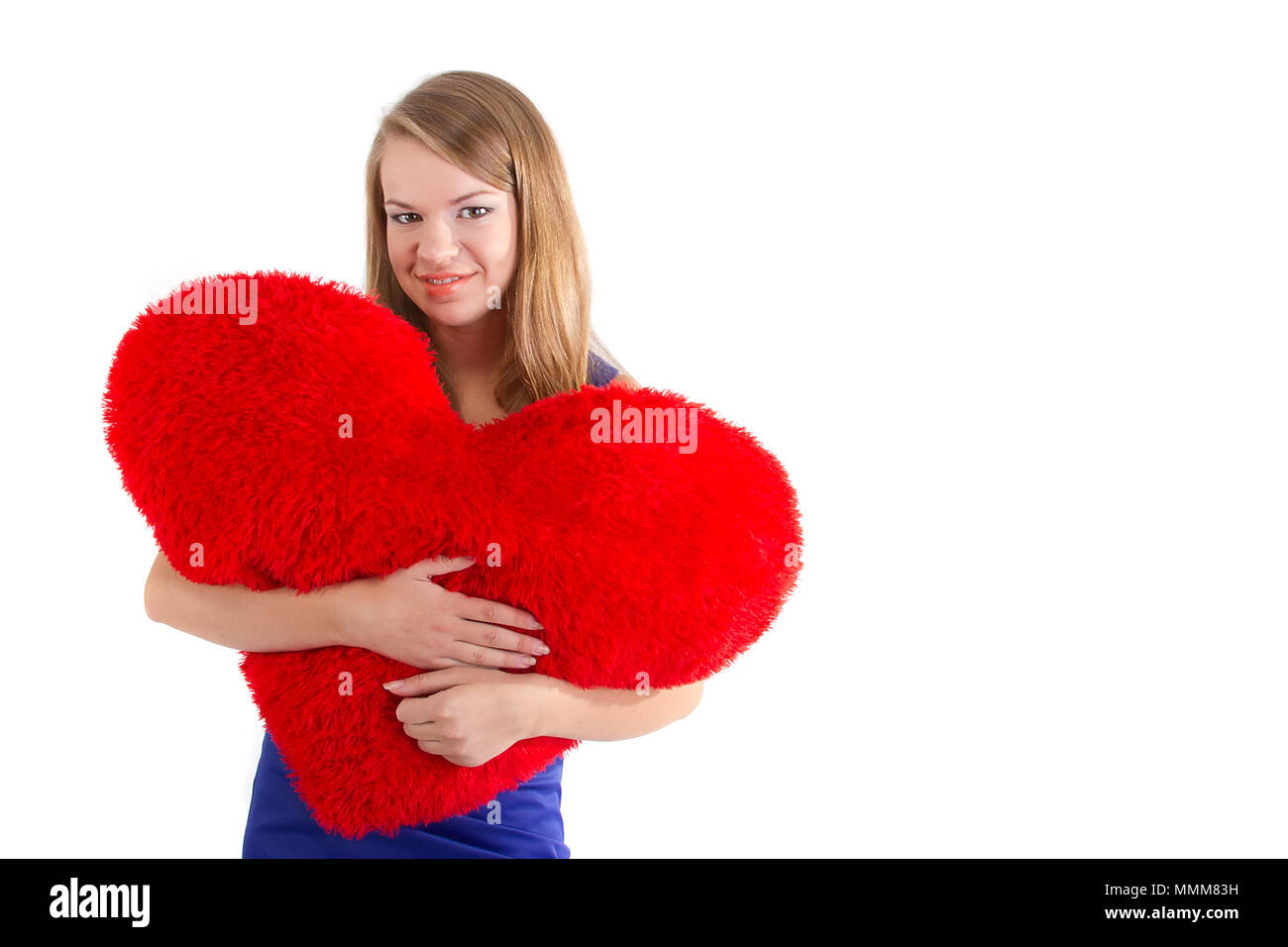 Young beautiful girl hugs a big soft heart. Feast of St. Valentine's ...