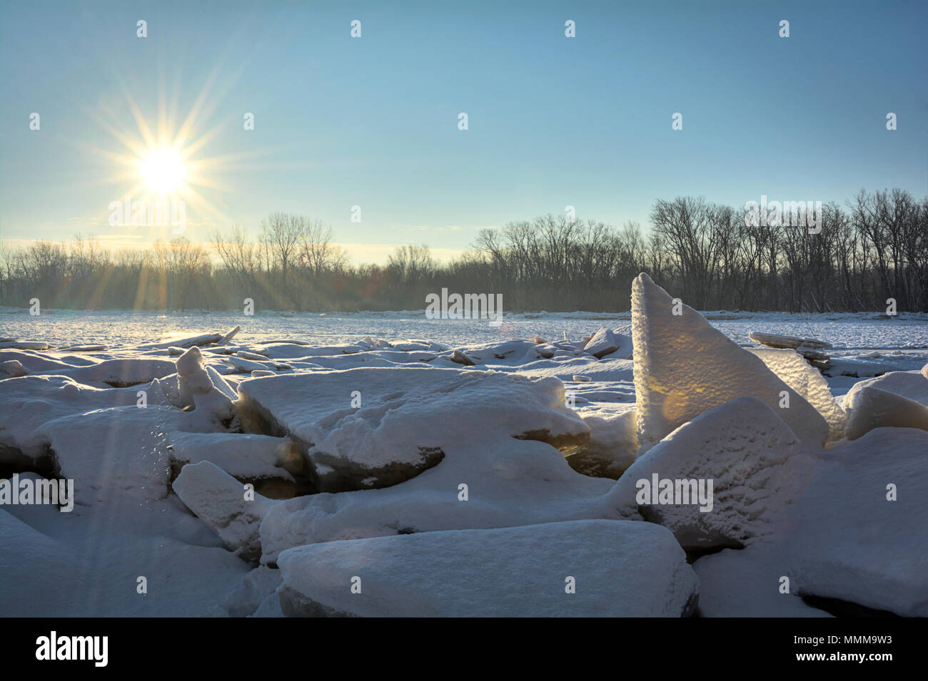 A beautiful snowy winter sunrise along the frozen Maumee River in ...